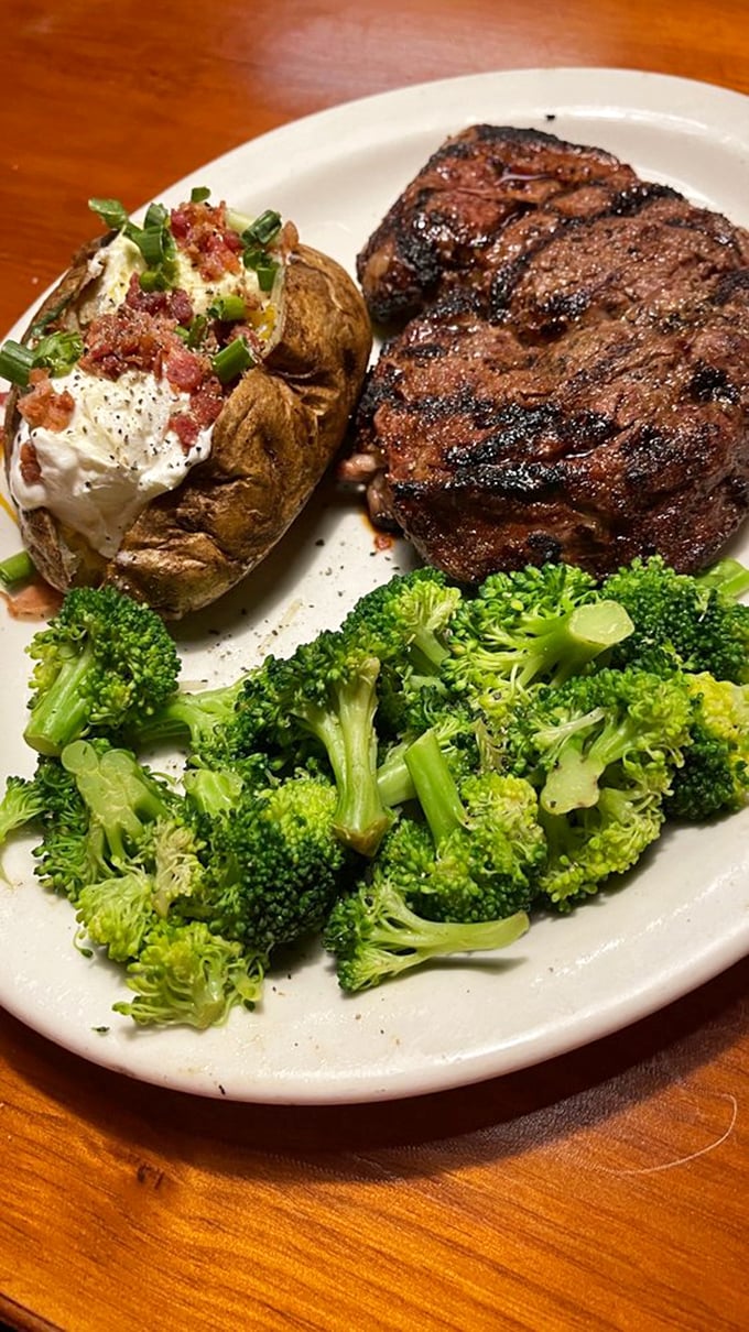 This isn't just a steak; it's a masterpiece with grill marks. The loaded baked potato and fresh broccoli provide the perfect supporting cast.