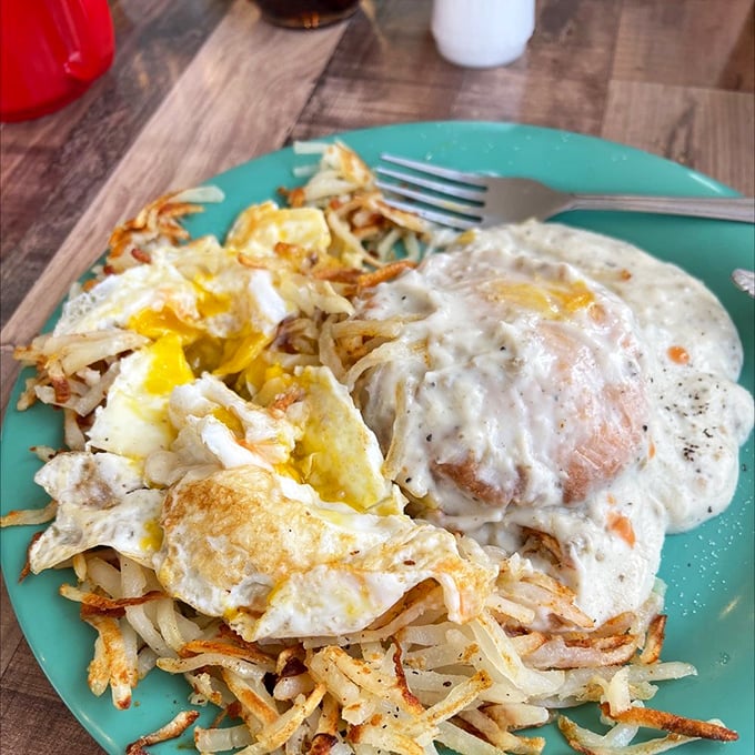The Holy Trinity of breakfast: crispy hash browns, eggs cooked just right, and biscuits submerged in a sea of heavenly gravy. Dietitians, avert your eyes.