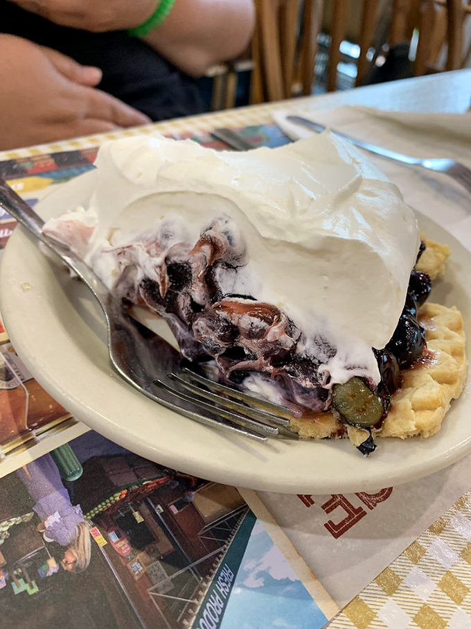This blueberry pie isn't messing around. With a mountain of whipped cream and berries that pop with flavor, it's summer captured in a perfect slice.