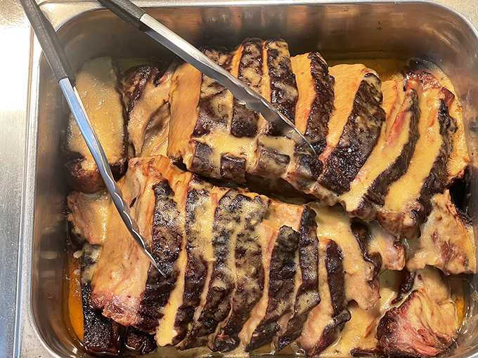 This isn't just meat; it's a sermon on patience. Brisket sliced thick enough to make a Texan nod with approval, glistening with slow-cooked perfection.