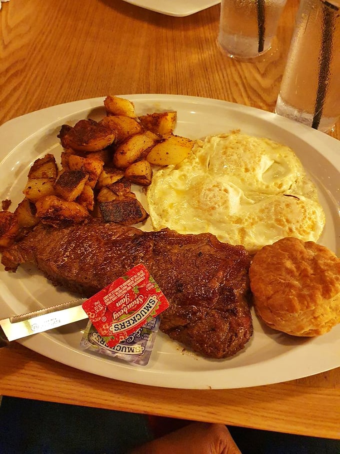 The holy trinity of breakfast: perfectly seared steak, sunny-side-up eggs, and home fries that could make a potato farmer weep with pride.