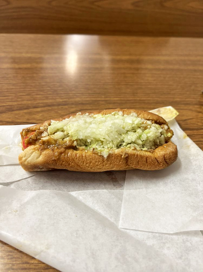 Behold, the Brunswick dog in all its glory – chili, slaw, and onions piled high on a perfectly steamed bun.