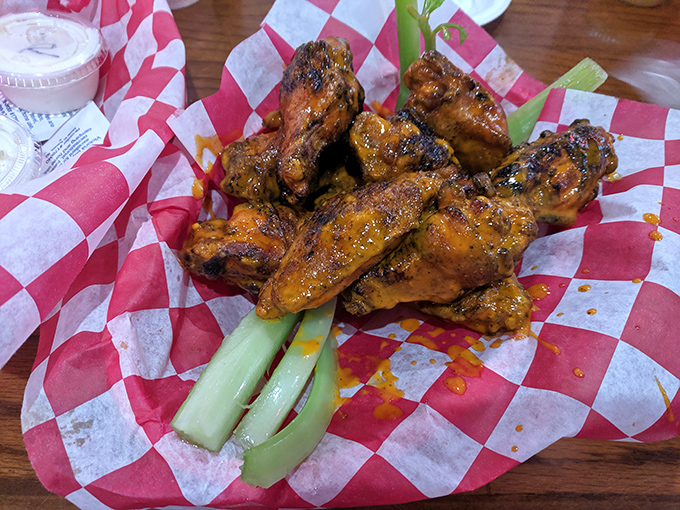 These aren't just wings; they're smoked, fried revelations served on red-checkered paper with celery standing by for moral support.