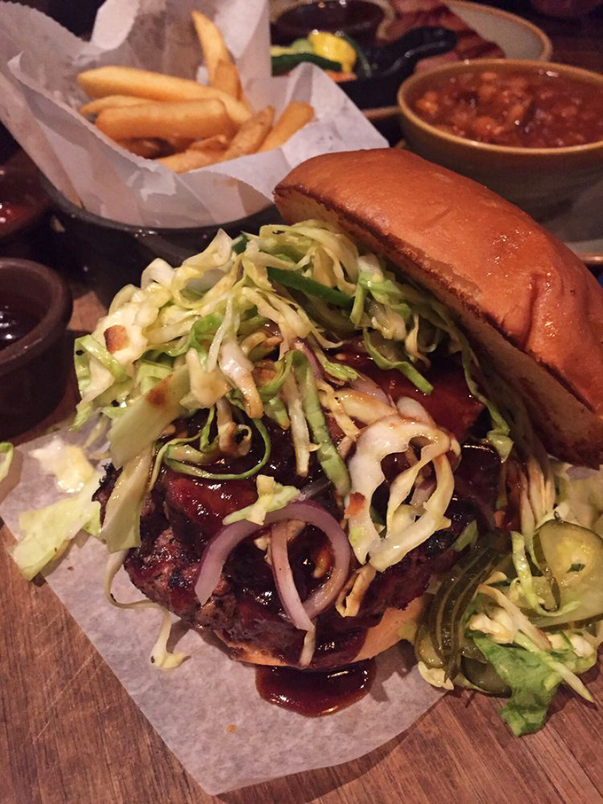 This isn't just a burger&mdash;it's a barbecue masterpiece topped with enough slaw to make your cardiologist nervous and your taste buds eternally grateful.