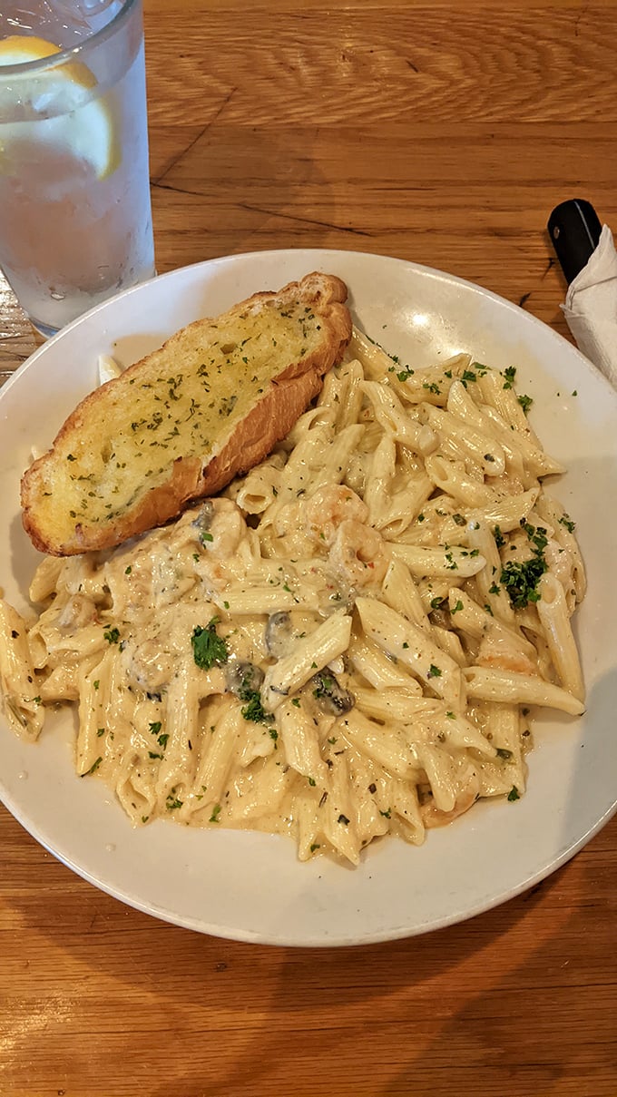 This creamy pasta isn't just comfort food&mdash;it's a full-blown comfort hug. The garlic bread stands ready for its supporting role in sauce-sopping perfection.