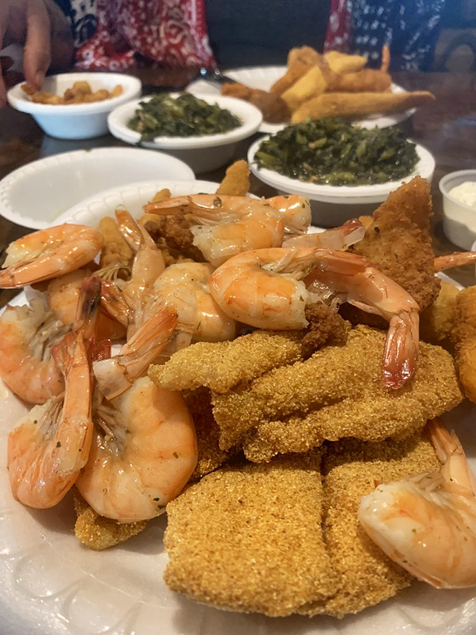 Golden-fried catfish mingles with plump shrimp on a plate that screams "Southern comfort." The greens are just there to ease your conscience.