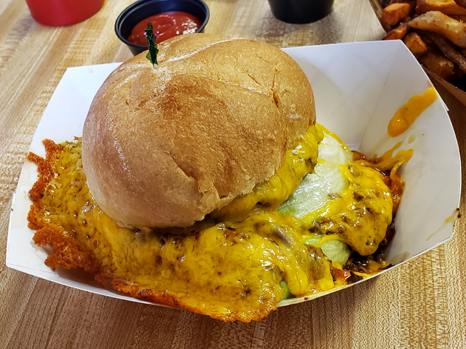 The cheese doesn't just top this burger&mdash;it embraces it, creating a crispy, lacy halo that transforms an everyday meal into a religious experience.