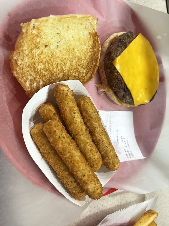 The classic combo that's launched a thousand food comas: a perfectly charred burger with cheese and crispy fries that demand to be savored. 