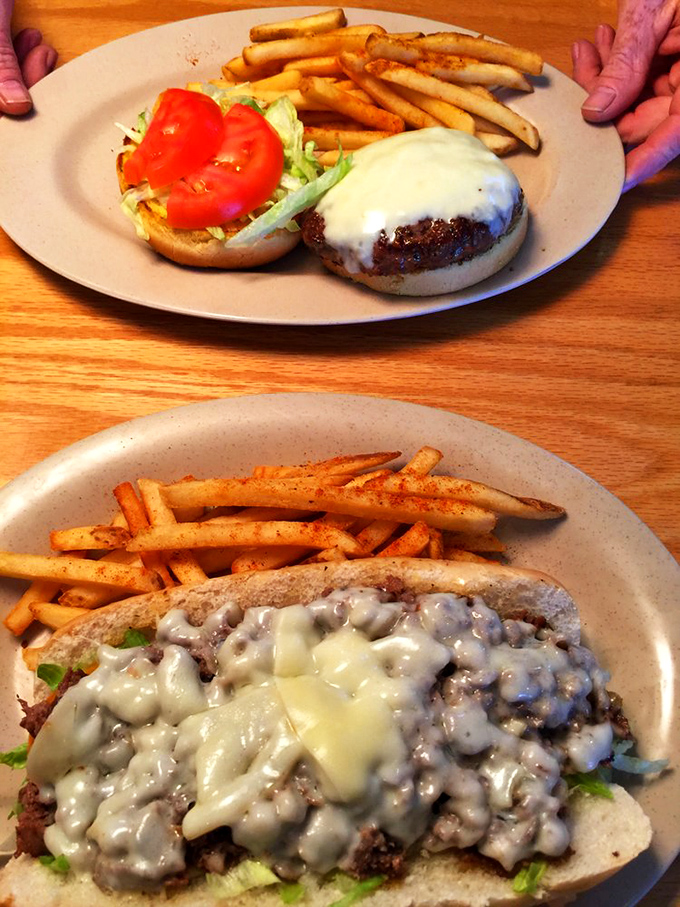 The melted cheese cascades down the burger like a dairy waterfall, while those seasoned fries stand ready for their supporting role.