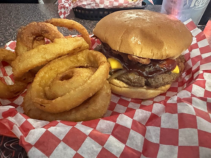 The perfect marriage: a juicy burger with a side of golden onion rings. Some relationships are just meant to be.