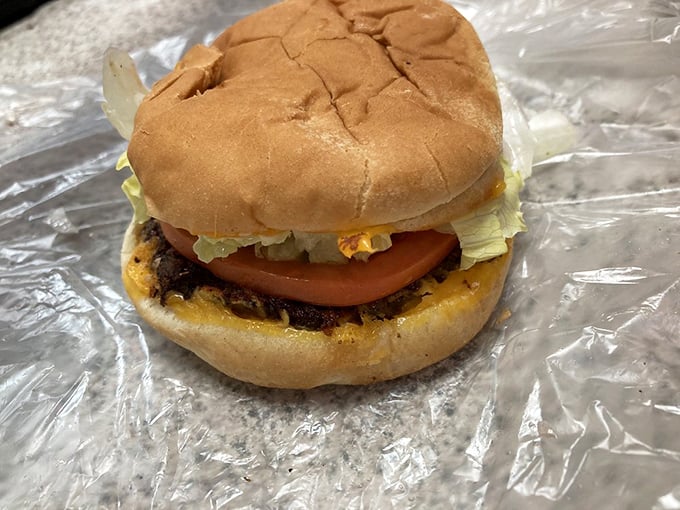 Behold the architecture of satisfaction&mdash;melted cheese cascading over a hand-ground patty, fresh lettuce, and a slice of tomato that actually tastes like tomato.
