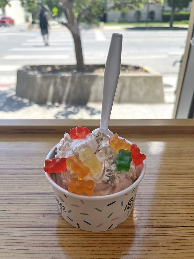 Gummy bears living their best life atop creamy perfection. This isn't just dessert; it's a tiny, colorful celebration in a cup.