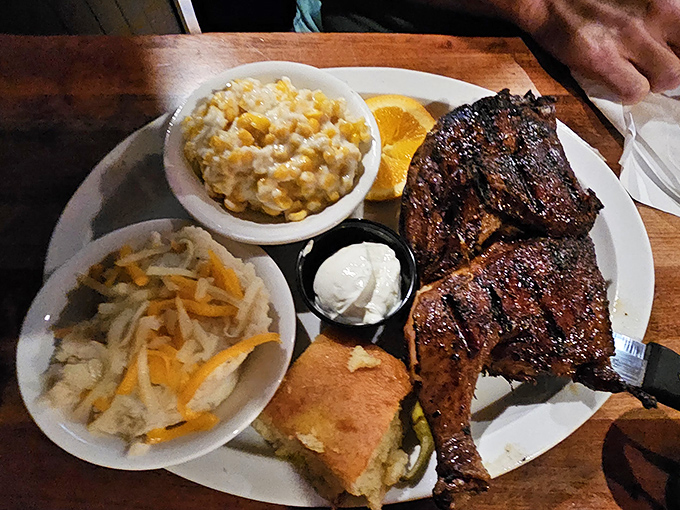 This plate screams "Southern comfort"—juicy chicken alongside creamy corn pudding and tangy slaw. The cornbread is just showing off at this point.