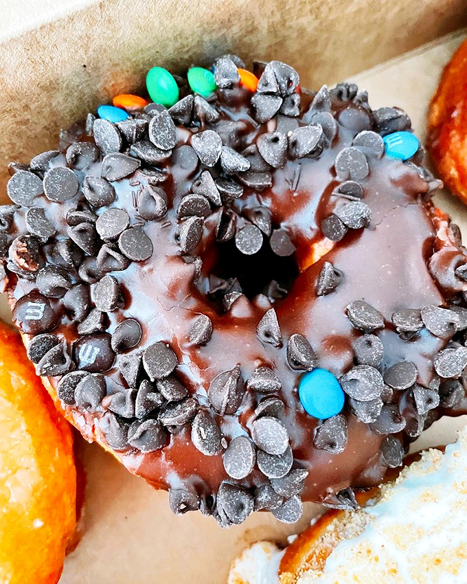 Chocolate chips nestled in chocolate glaze atop a chocolate donut&mdash;proof that sometimes more really is more, especially when chocolate is involved.