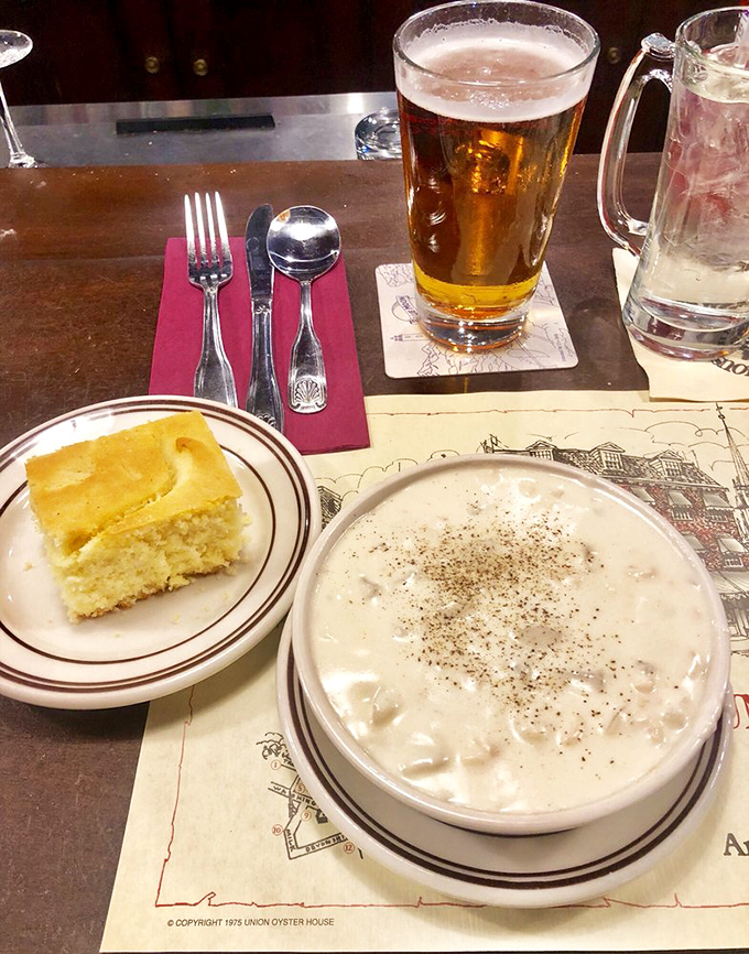 The holy trinity of Boston comfort: golden cornbread, a perfectly poured beer, and clam chowder so authentic it should come with its own history lesson.