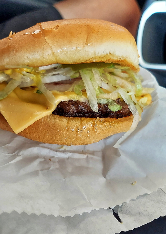 Behold the architecture of joy&mdash;melted cheese cascading over a perfectly grilled patty, fresh veggies adding height and crunch. Burger engineering at its finest.