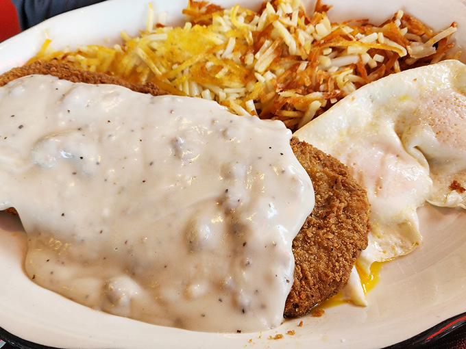 This isn't just breakfast&mdash;it's edible architecture. The country fried steak foundation, gravy middle layer, and sunny-side up roof create the house that hunger built. 