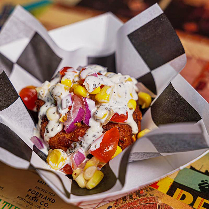 This crab cake doesn't just sit there looking pretty&mdash;it comes dressed for success with sweet corn, diced tomatoes, and a sauce that deserves its own fan club.