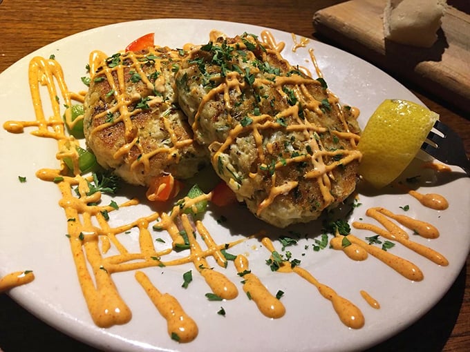 Crab cakes that don't hide behind fillers. That drizzle of sauce isn't showing off&mdash;it's just flexing a little.