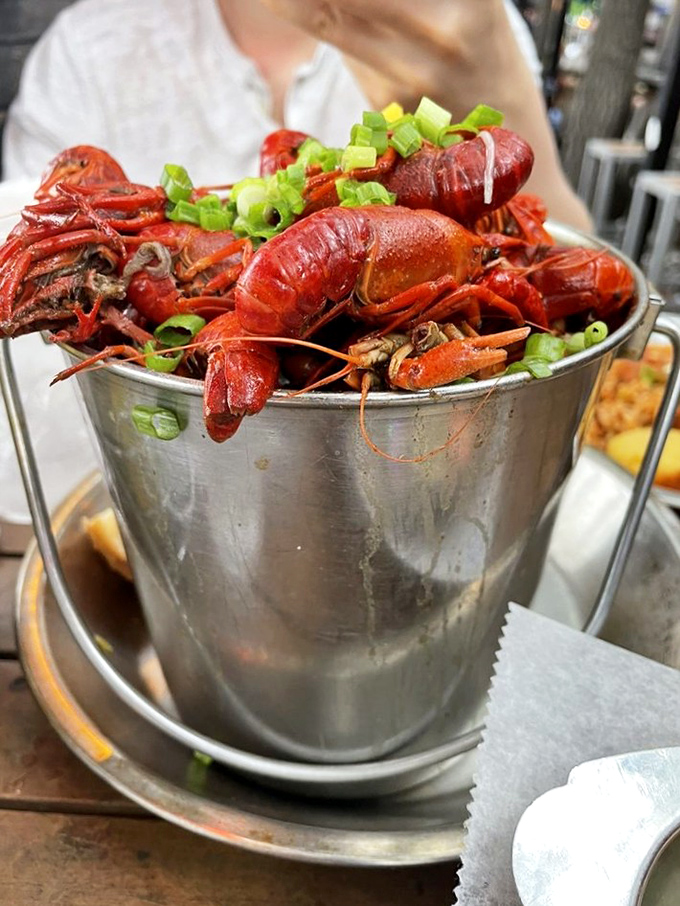 Behold the bucket o' crawfish&mdash;tiny crimson crustaceans that demand you slow down, get messy, and embrace the moment.