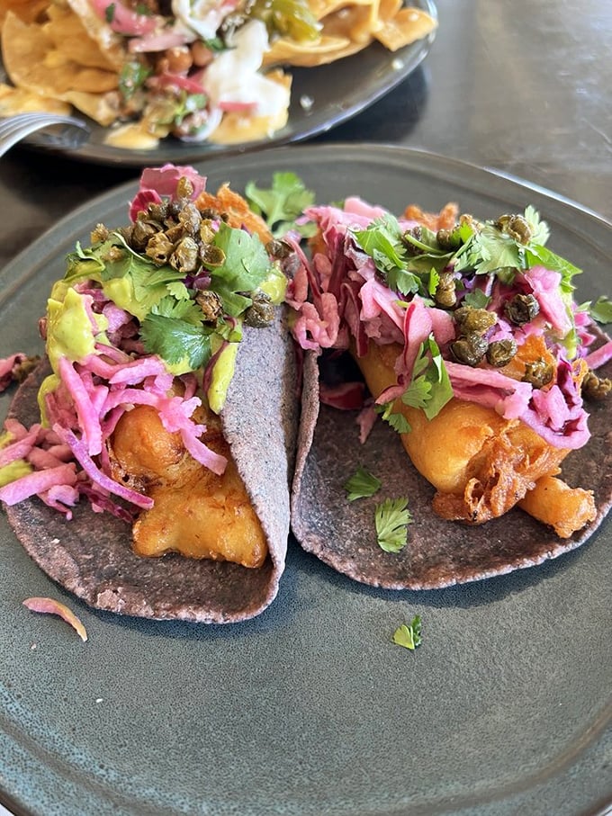 Crispy fish, vibrant slaw, and what appears to be capers? It's like the ocean and garden had a delicious argument on your plate.