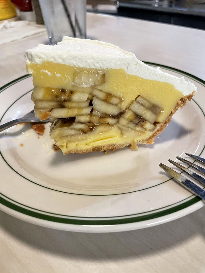 The cross-section reveals the architectural marvel that is The Apple Pan's banana cream pie &ndash; perfectly engineered layers that should be studied in culinary school.