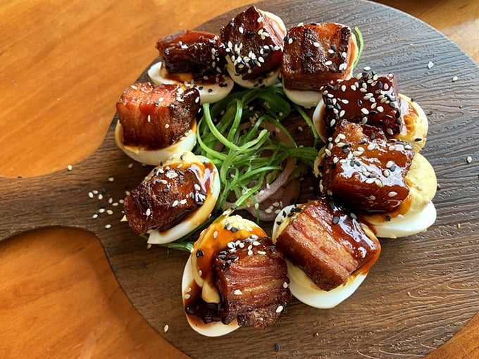 Whoever said "deviled eggs are just picnic food" clearly never experienced these glazed pork belly masterpieces that redefine a classic.