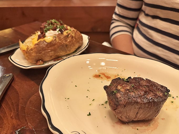 The perfect partnership: a flawlessly executed filet alongside a loaded baked potato that's dressed better than most people at formal events.