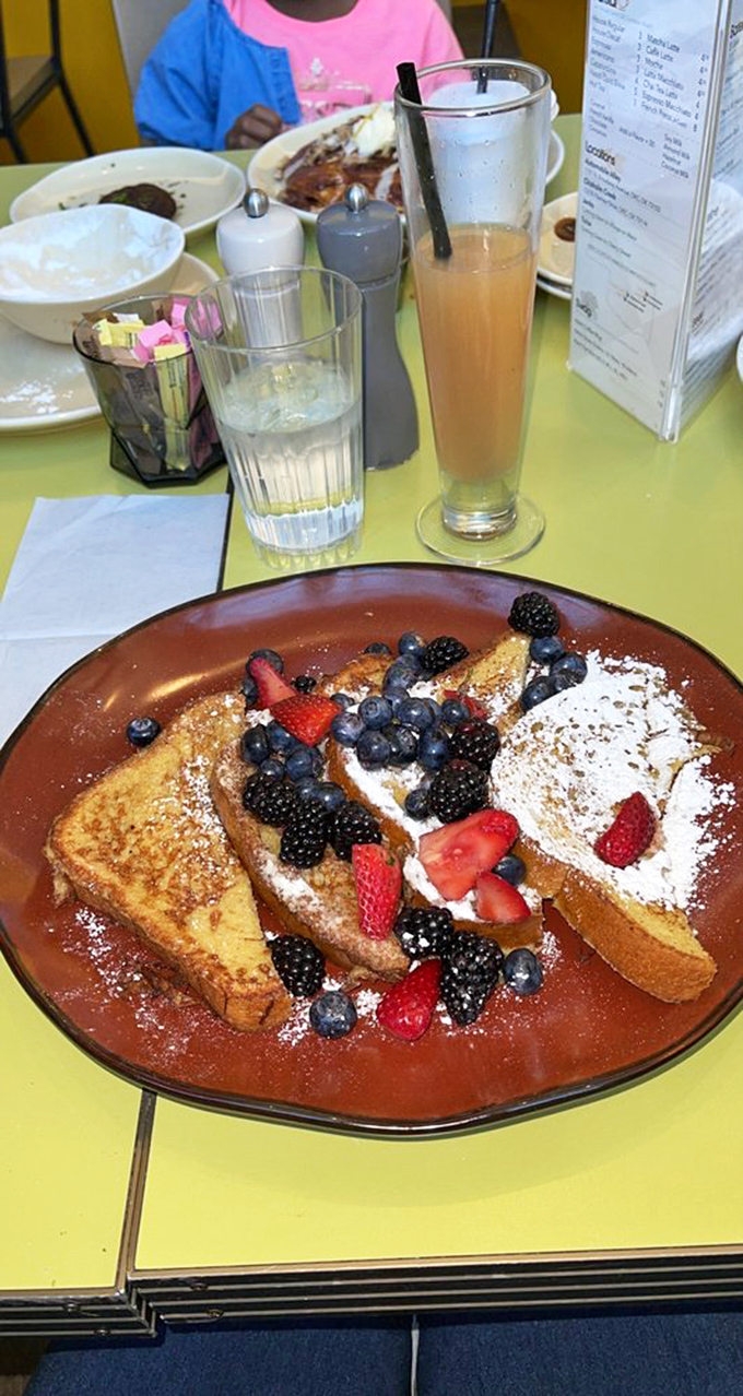 Breakfast or dessert? The line blurs deliciously when powdered sugar and fresh berries join the party. That tall glass of juice is just showing off.