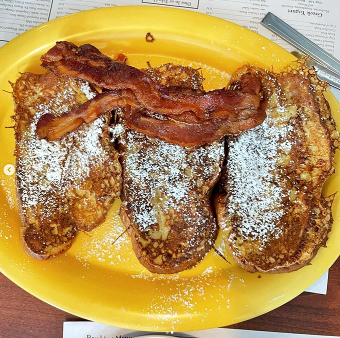 French toast that puts ordinary breakfast to shame. That bacon strip isn't garnish &ndash; it's the exclamation point on a morning masterpiece.