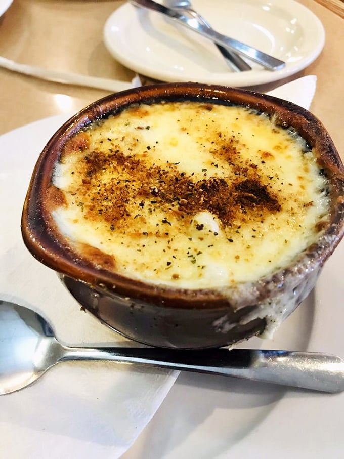 French onion soup so good it deserves its own ZIP code &ndash; a bubbling cauldron of caramelized promise beneath that cheesy crust.