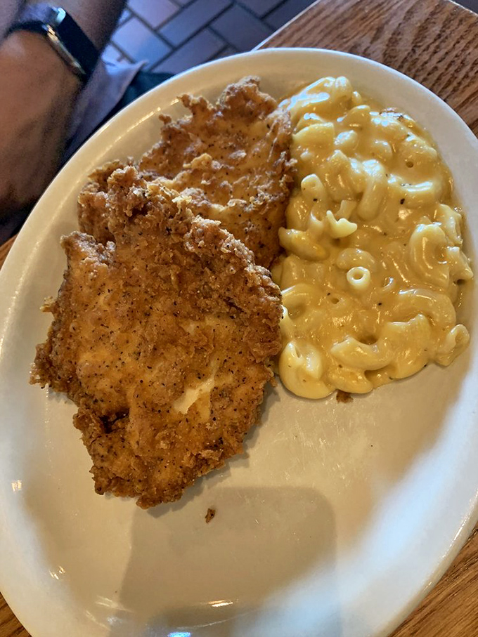 This golden-fried chicken and mac & cheese combo isn't just a meal, it's what happiness would look like if it took physical form.