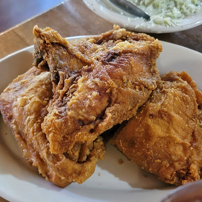 Crispy, crackling skin protecting juicy meat within&mdash;this isn't just fried chicken, it's edible Southern heritage on a plate.