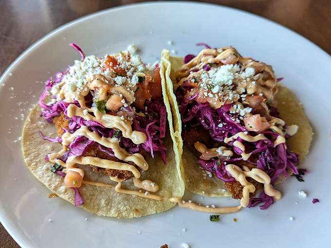 The fish taco close-up reveals the architectural perfection&mdash;crispy exterior, flaky interior, with sauce drizzled like Jackson Pollock had a very delicious day. 