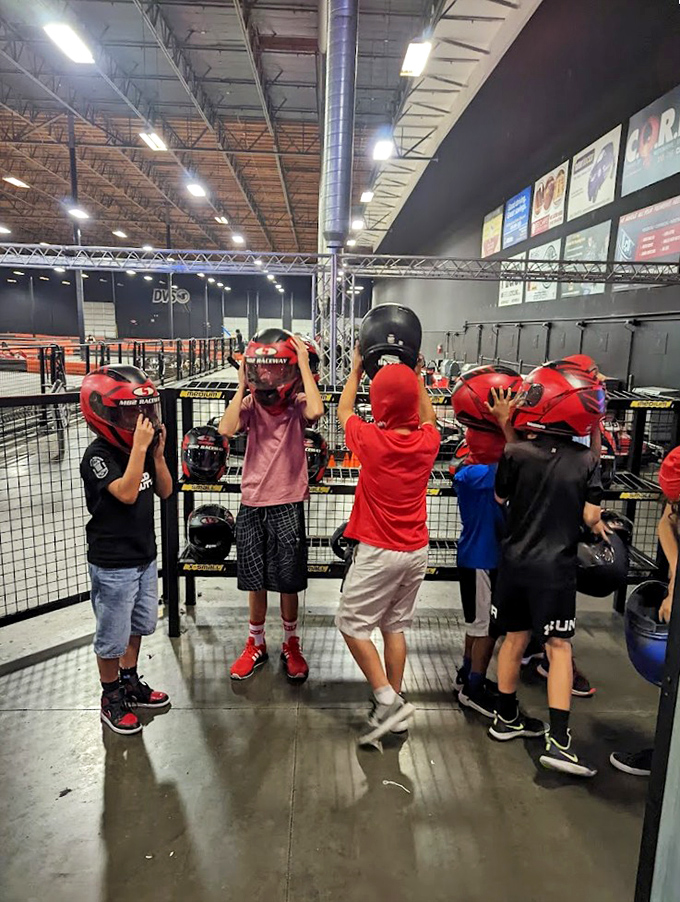 Future racing champions selecting their helmets with the seriousness of knights choosing armor for battle. Safety first, victory second!
