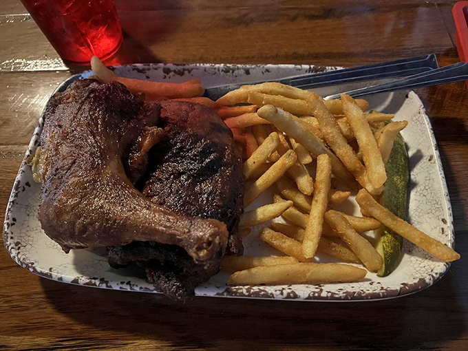 Smoke-kissed chicken that's so tender it practically falls off the bone, served with crispy fries and a pickle for good measure.