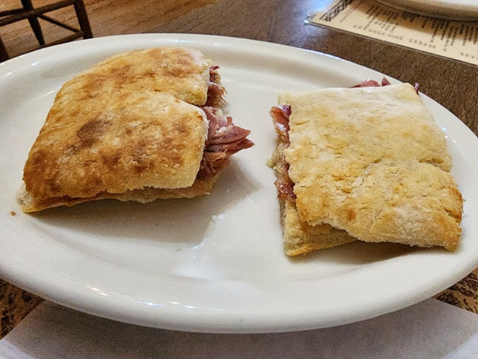 The ham biscuit in its natural habitat—split open to reveal that glorious Virginia country ham. Simplicity that somehow manages to be revolutionary.