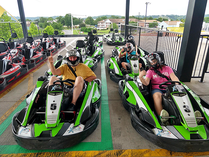 Drivers suited up and ready to challenge the track. The helmets may hide the grins, but the body language speaks volumes about the fun ahead.
