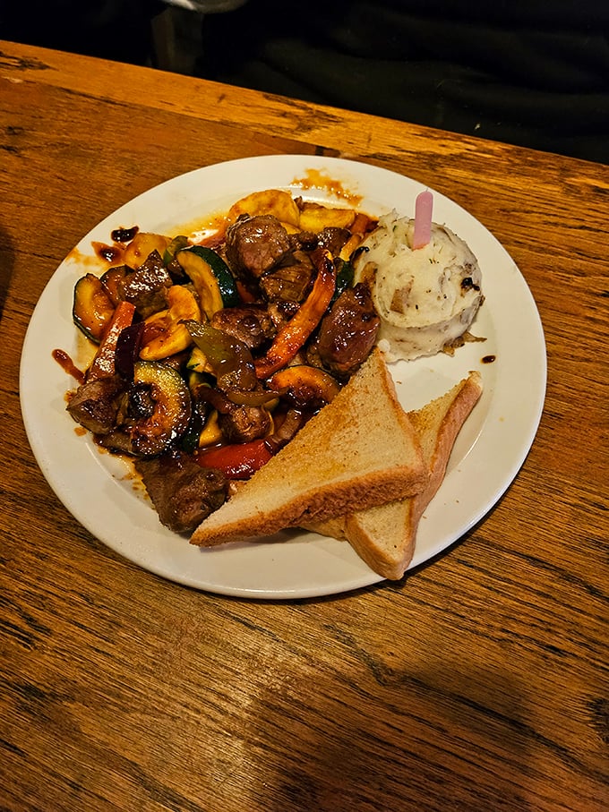 Beef tips and vegetables share the spotlight with the real star – a perfect cloud of mashed potatoes that makes you wonder if potatoes have been holding out on you all these years.