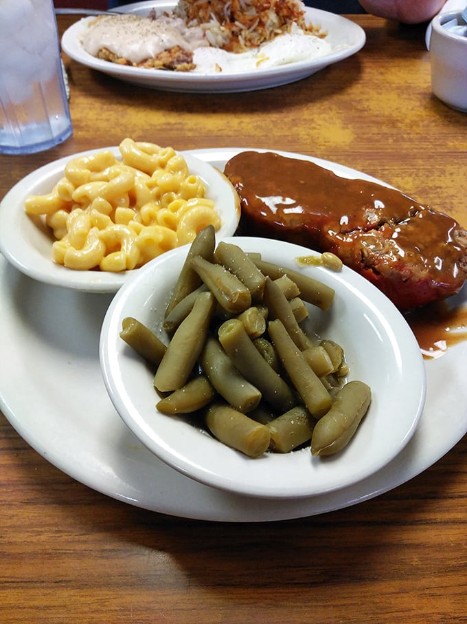When gravy cascades over meatloaf like this, vegetables become supporting actors in the greatest comfort food drama ever staged.