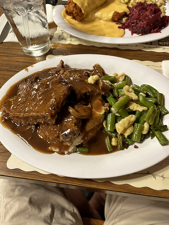 The gravy cascading over this meatloaf is performing what can only be described as a delicious magic trick.