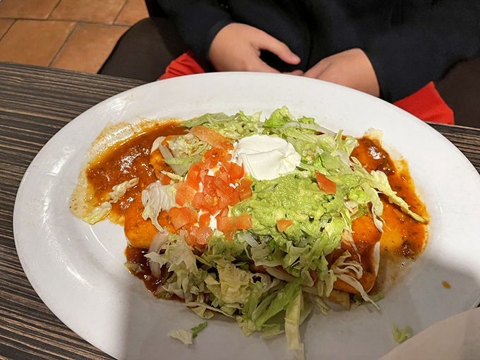 Buried under fresh lettuce, tomatoes, and a dollop of sour cream, this burrito isn't hiding&mdash;it's building anticipation for the flavor fiesta inside.