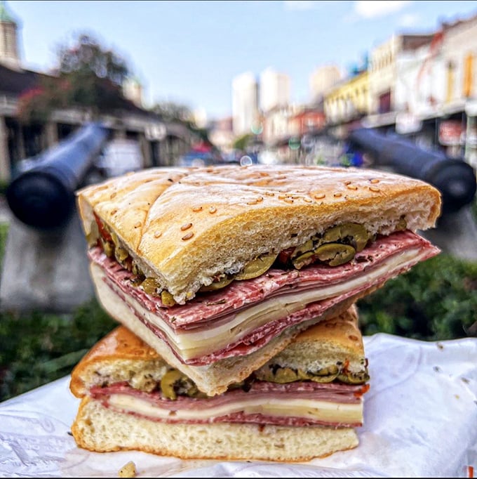 Two quarters stacked like delicious history books, telling the story of Sicilian immigrants who forever changed New Orleans' food landscape with each perfect bite.