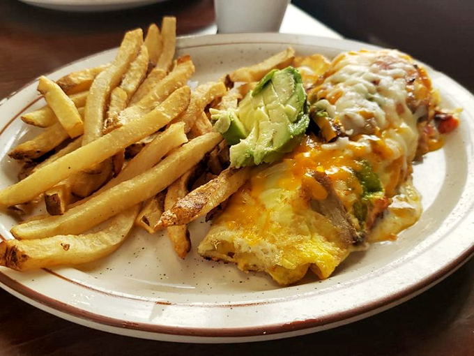 This omelet doesn't just sit on the plate&mdash;it commands it. Topped with avocado and melted cheese, with perfectly crisp fries standing at attention alongside.