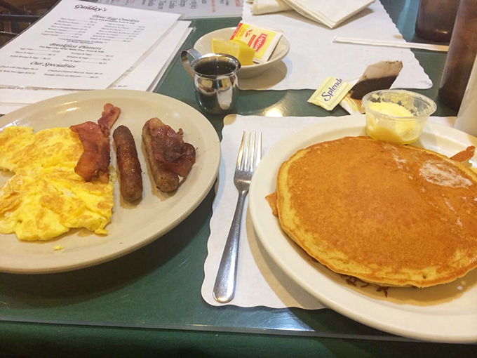The breakfast trifecta: golden eggs, perfectly crisped bacon, and a pancake so good it deserves its own Instagram account.