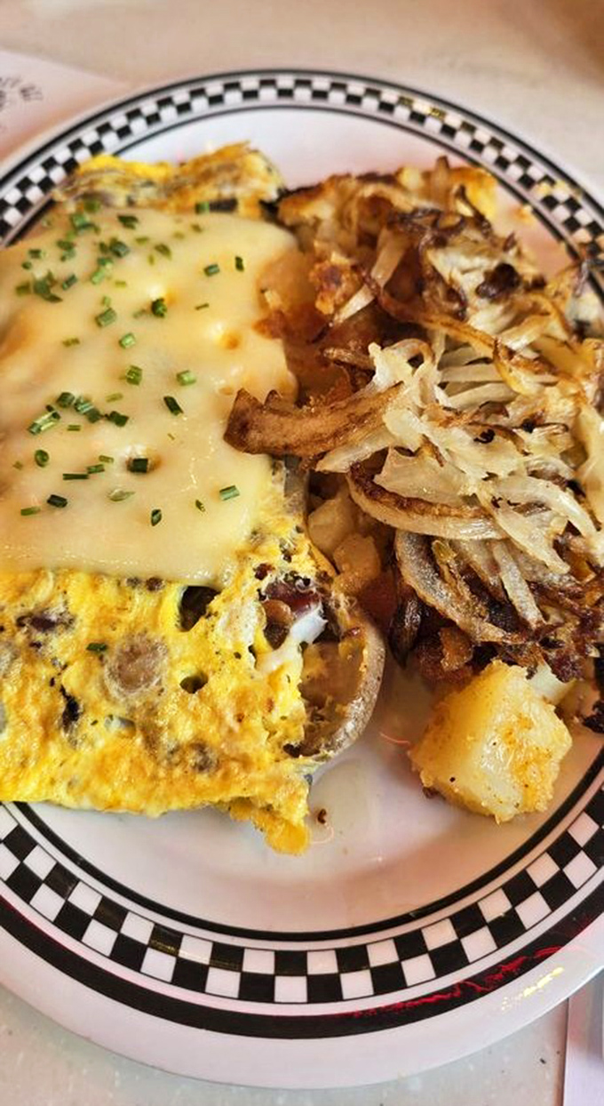 This isn't just an omelet – it's a masterclass in breakfast architecture, with perfectly melted cheese and home fries that achieve the ideal crisp-to-tender ratio.