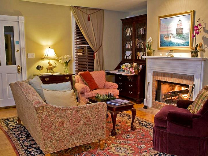 A fireplace that's witnessed a century of conversations, now waiting for yours. That oriental rug has probably heard some fascinating stories.
