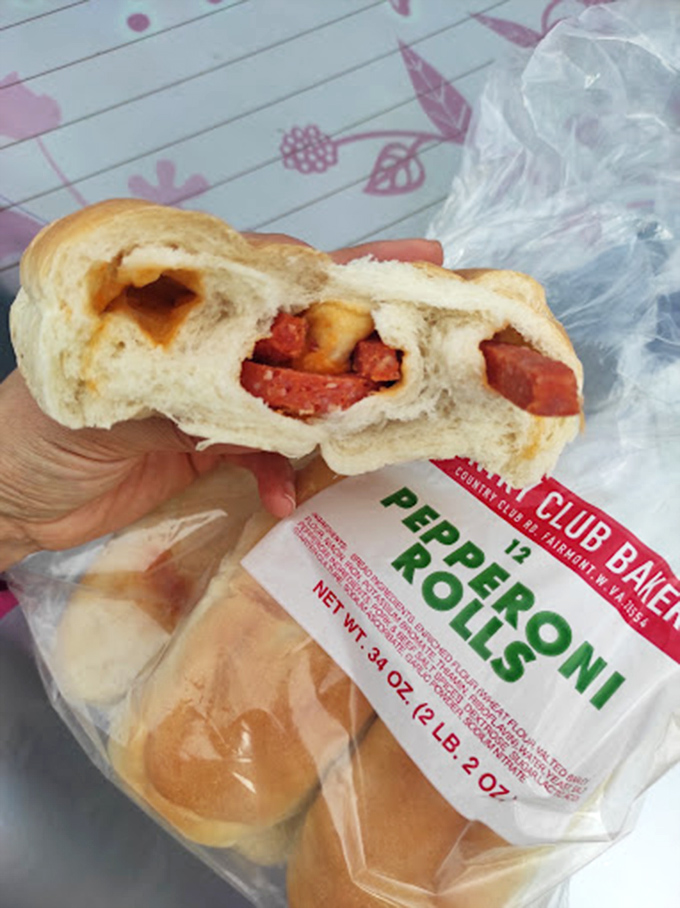 Behold the perfect bite – where bread meets meat in holy matrimony. The pepperoni peeks through like hidden treasure, promising spicy satisfaction with every mouthful.