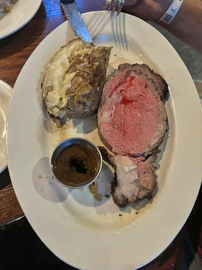 This prime rib doesn't just melt in your mouth—it practically files the divorce papers with your diet. That loaded potato is its willing accomplice.