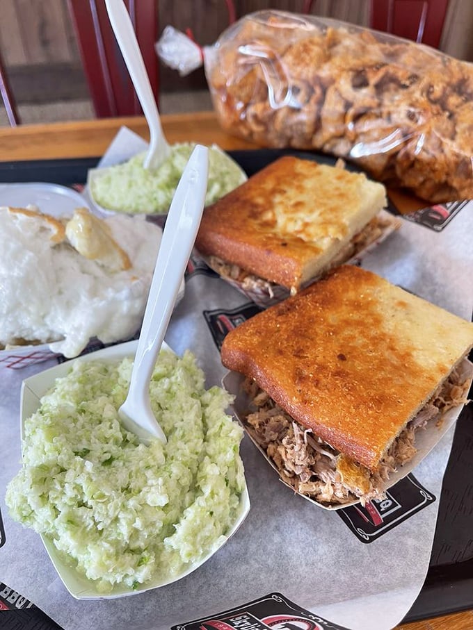 Eastern Carolina's holy trinity: vinegary coleslaw, golden cornbread, and perfectly chopped pork. Barbecue poetry on a paper plate.